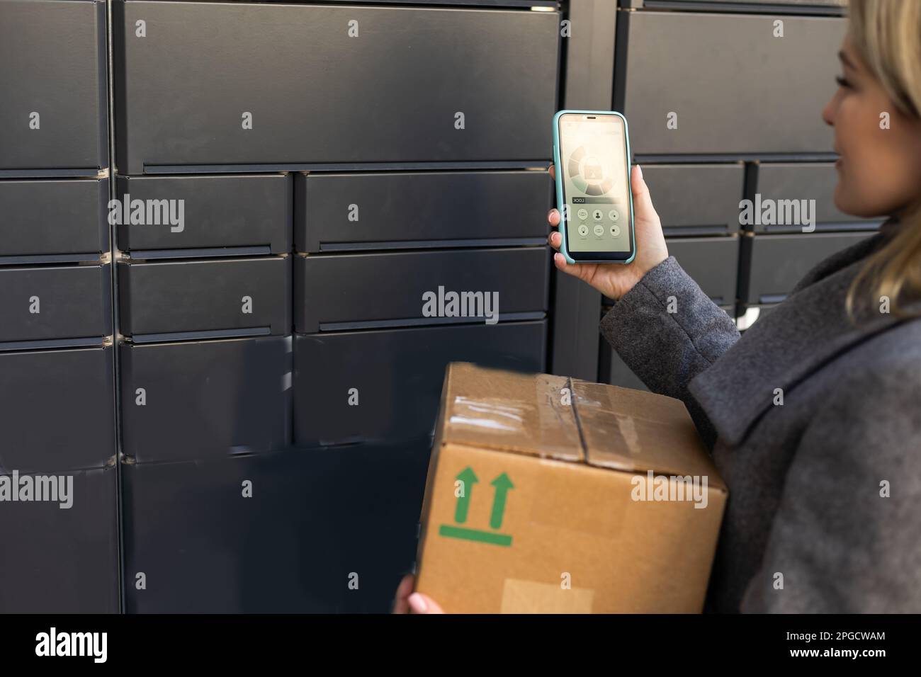 Beautiful woman picking up a package from a smart electronic steel ...