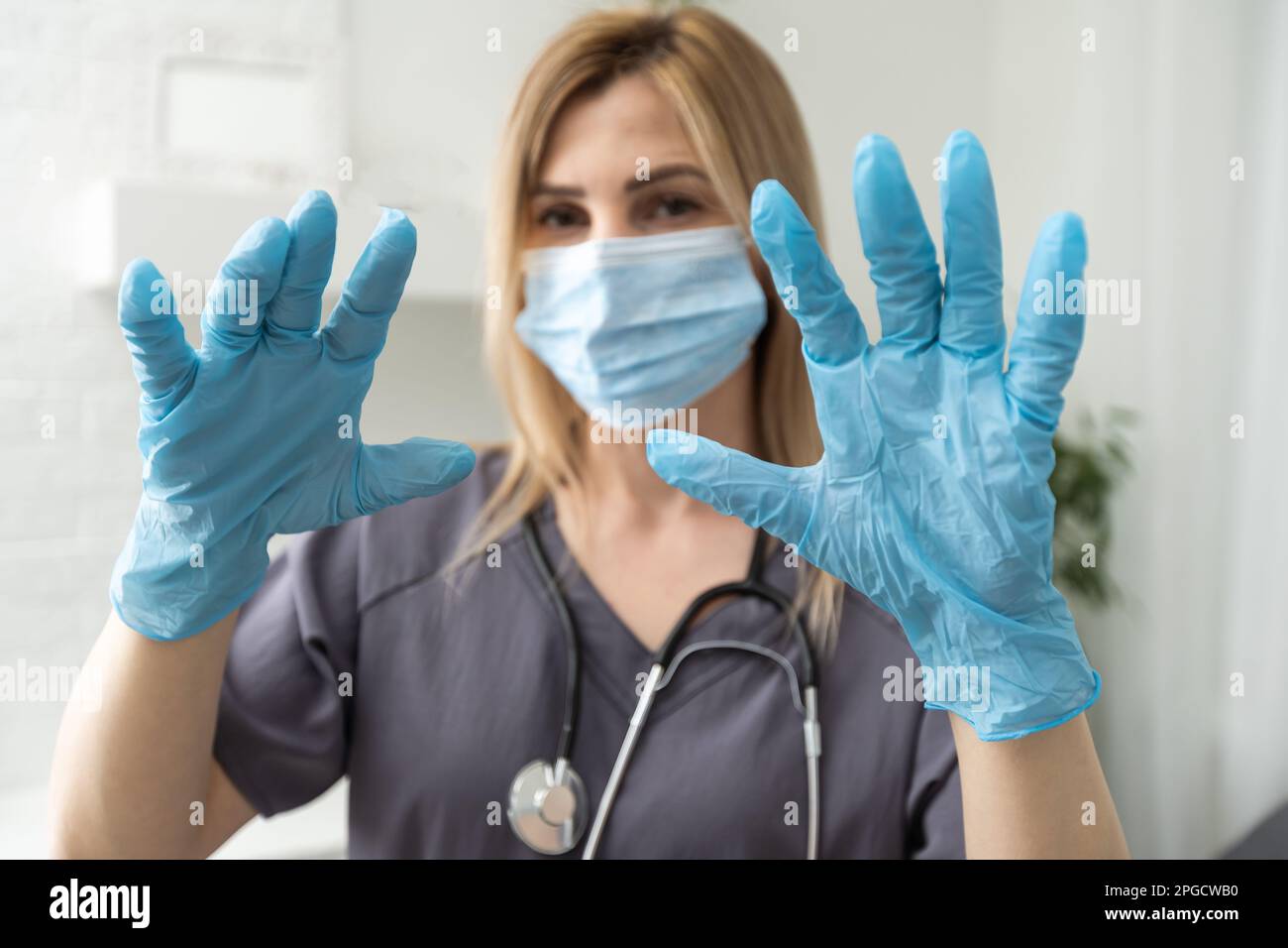 female doctor's hands in nitrile blue gloves show finger Stock Photo ...