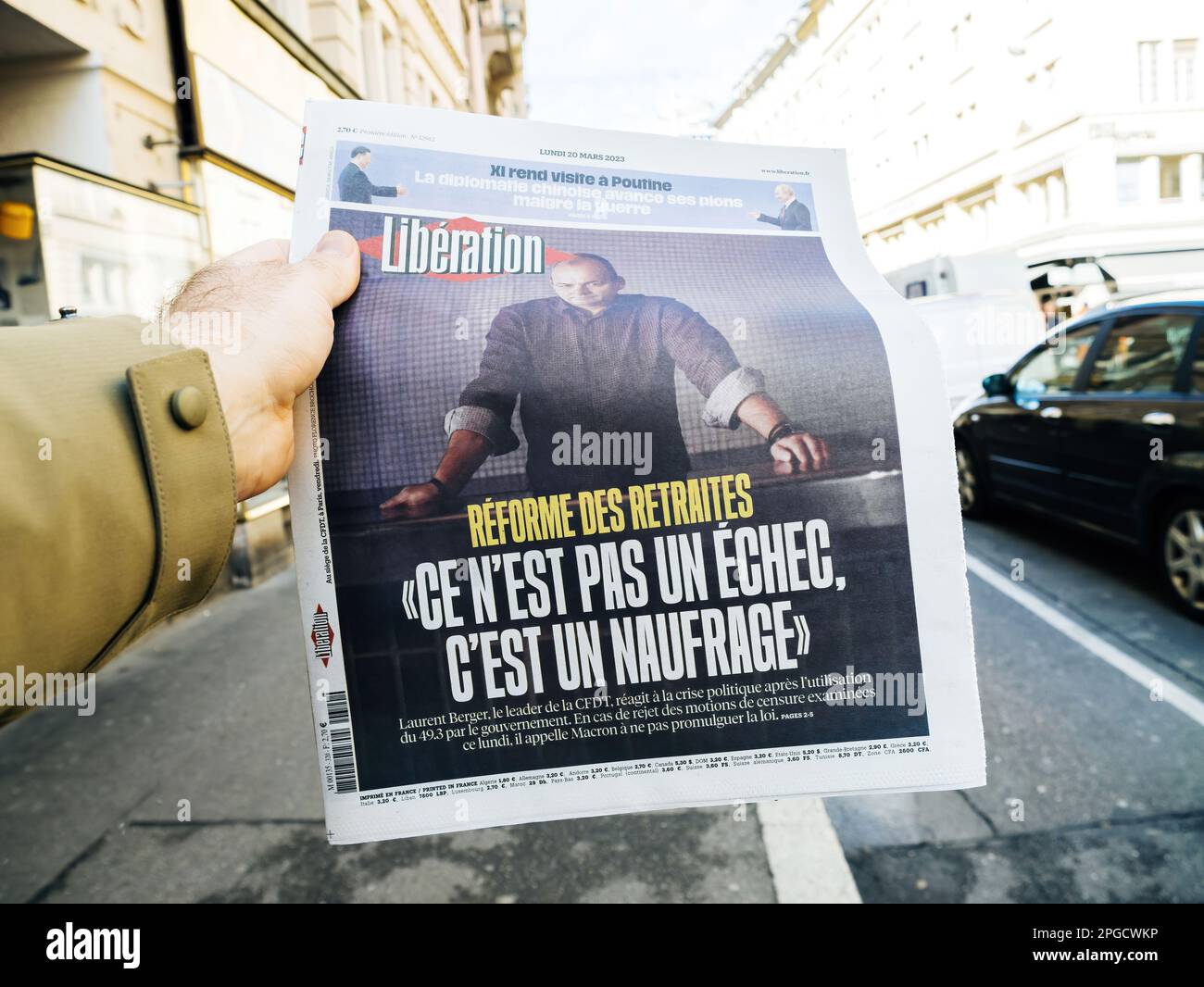 Paris, France - Mar 20, 2023: Male hand reading Liberation newspaper ...