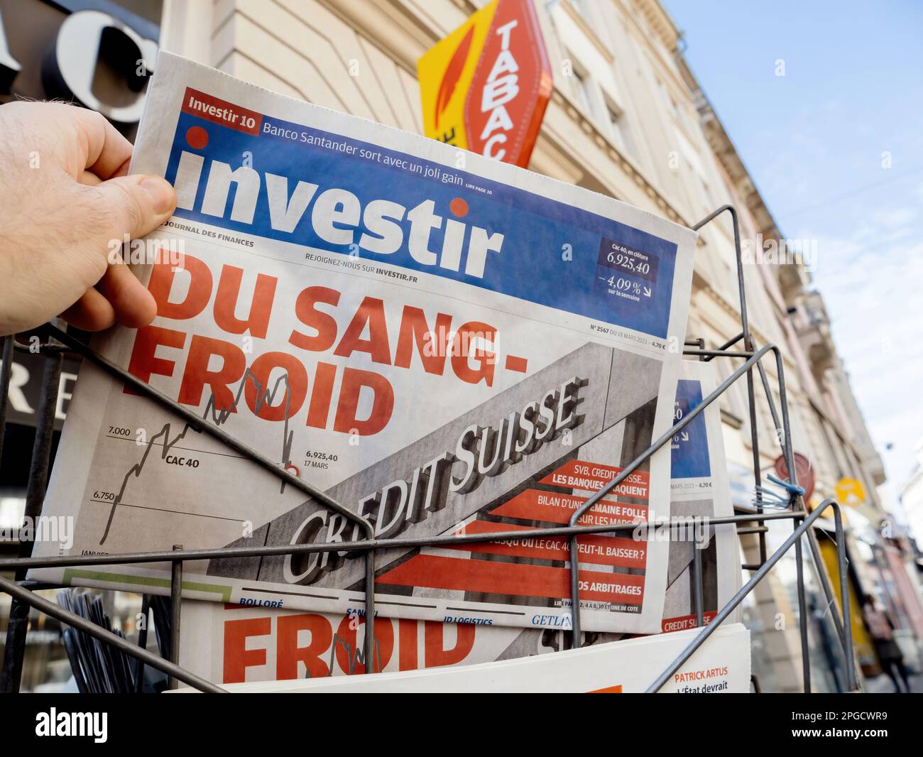 Paris, France - Mar 20, 2023: POV reading press at kiosk buy newspaper ...
