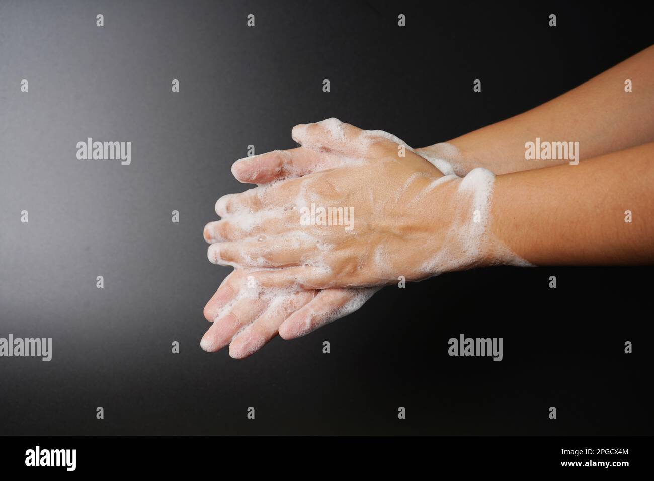 Hand washing with hand wash on dark background Stock Photo - Alamy