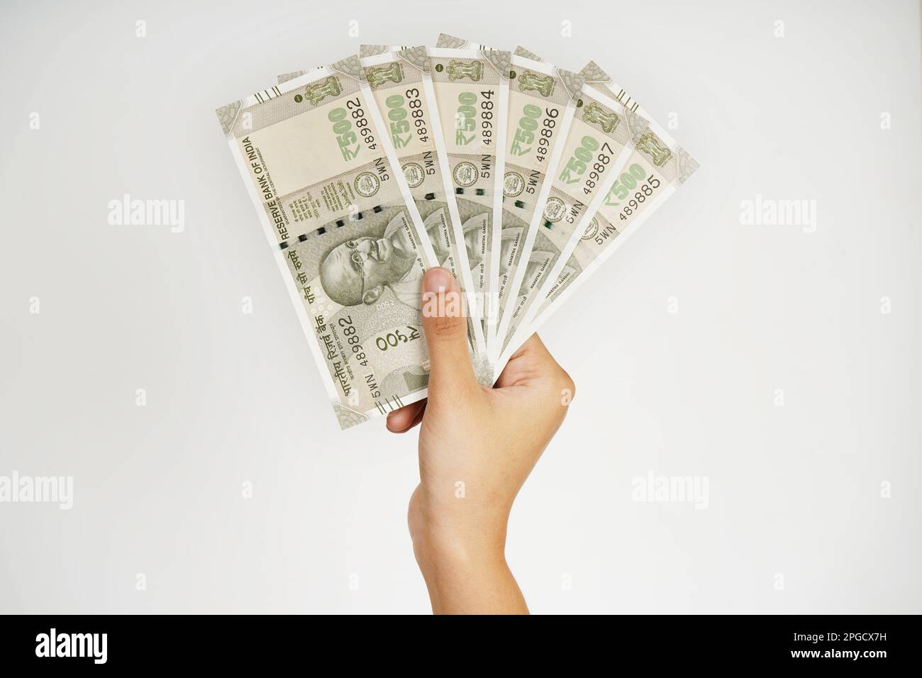 Indian rupees in hand, india currency note Stock Photo - Alamy
