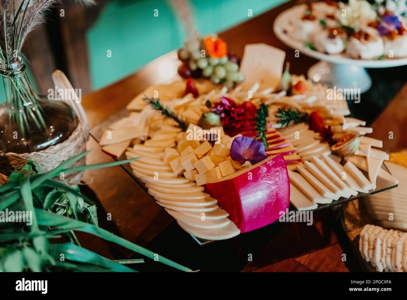 A selection of food dishes laid out on multiple wooden tables in a ...