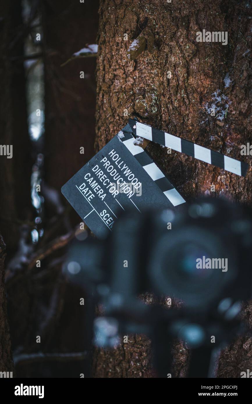 A movie slate board clapper seen through a blurred digital camera Stock ...