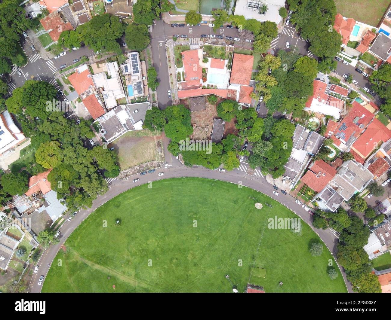 An aerial view of a modern urban cityscape featuring a winding circular ...