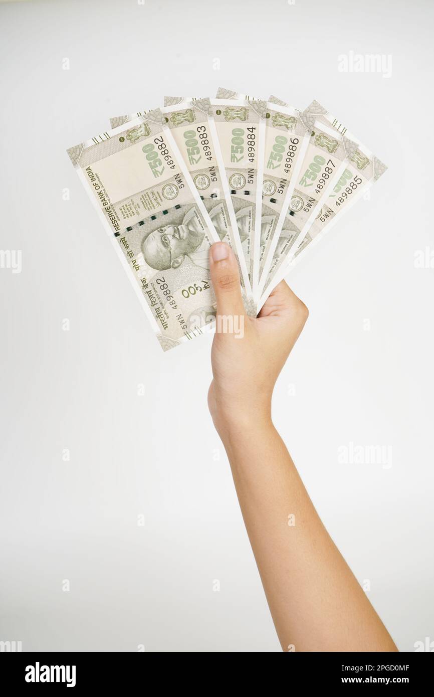 Indian currency note in hand on white background, indian rupees Stock ...