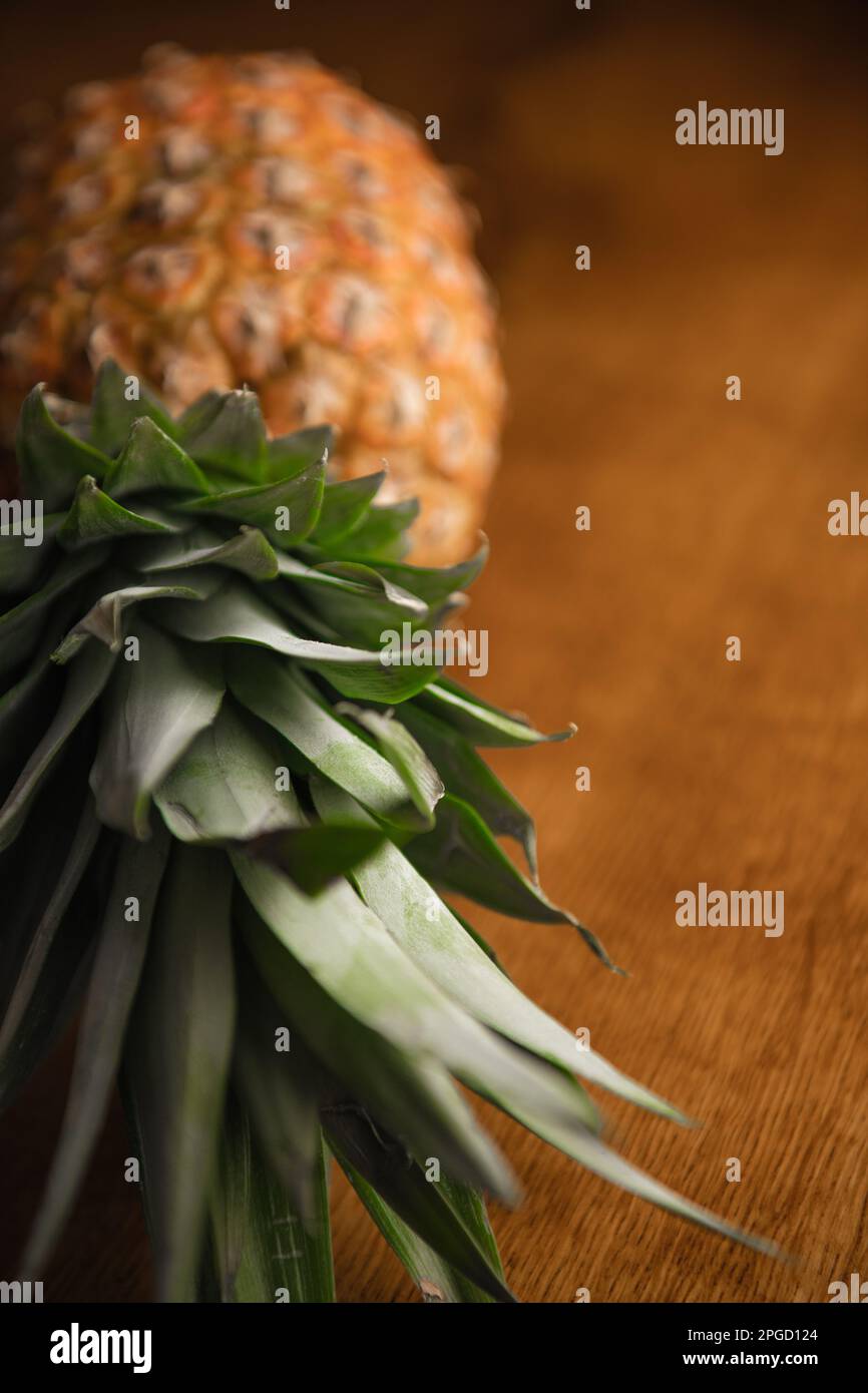 Pineapple with wood background Stock Photo - Alamy