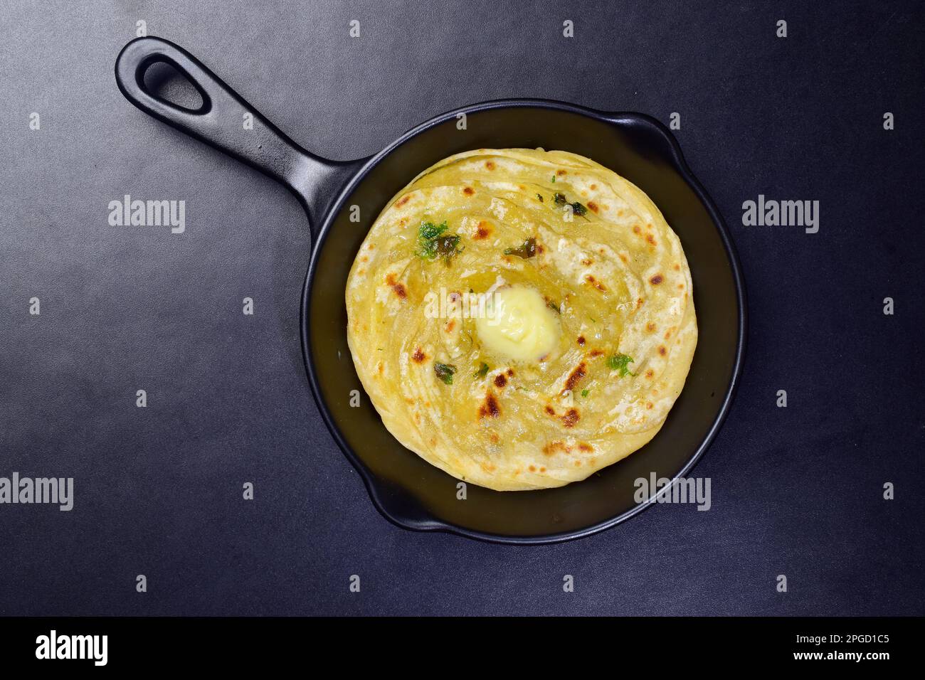 Top view of laccha paratha with butter in pan Stock Photo - Alamy