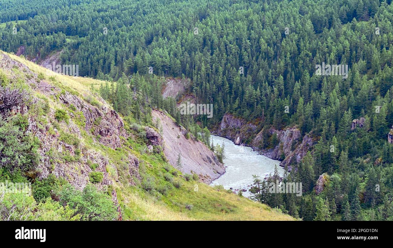 The narrow river Chuya in the canyons among the mountains flows to the ...