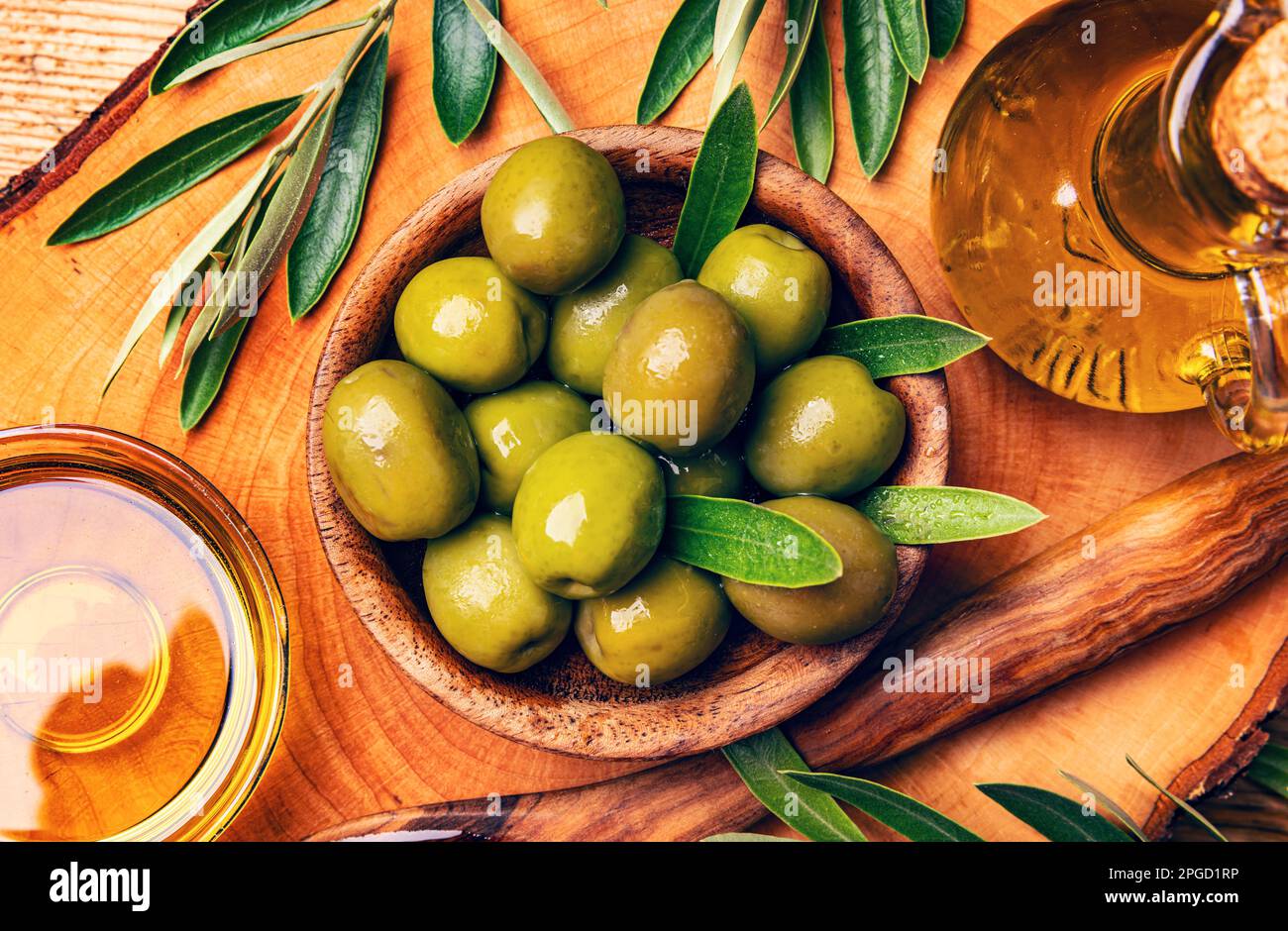 Green olives in wooden bowl, still life, flat lay, top view Stock Photo ...