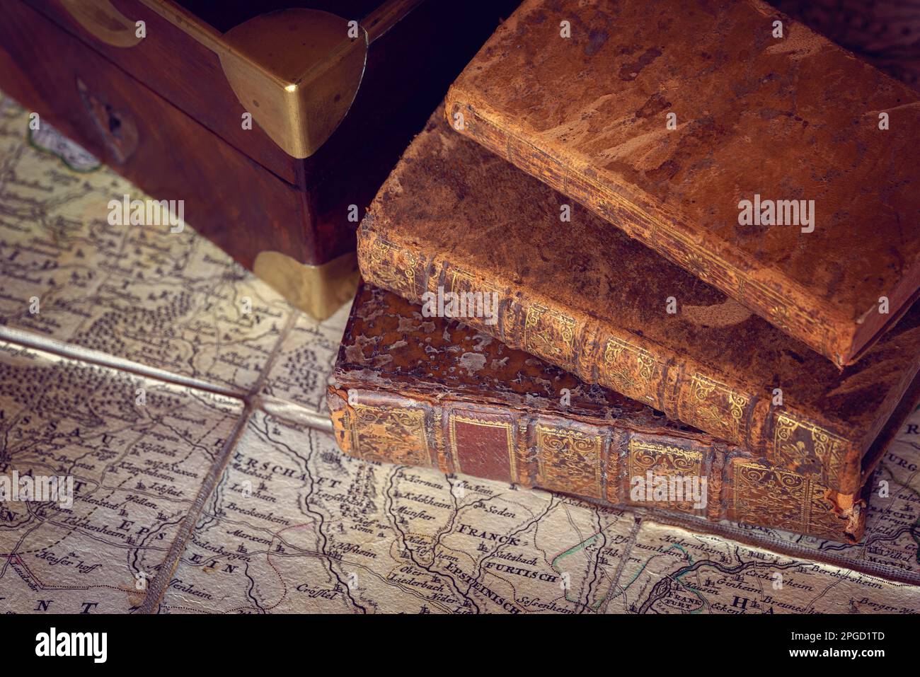 Pile of antique books with a leather cover and golden ornaments, close ...