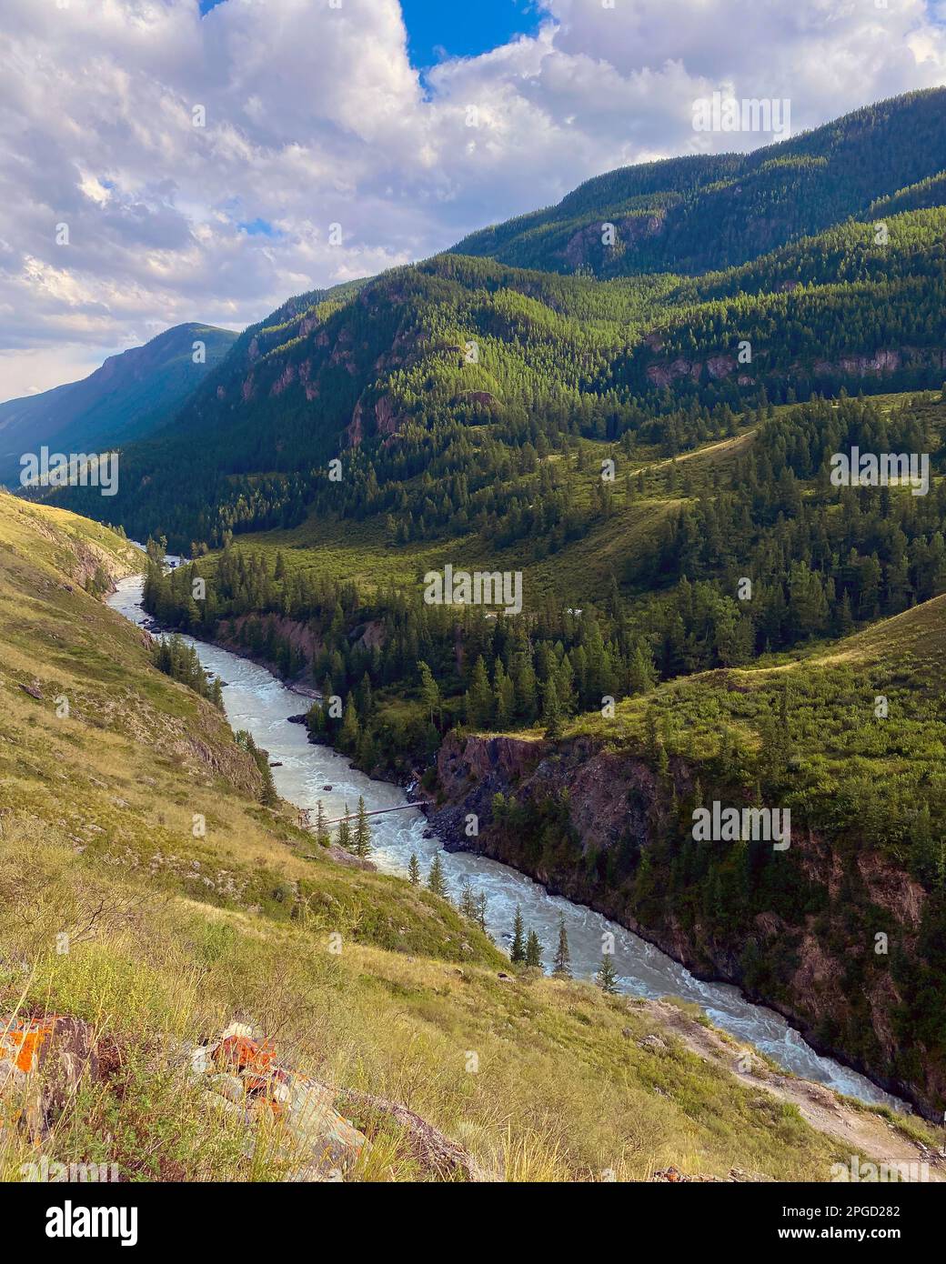 The narrow river Chuya in the canyons among the mountains flows with a ...