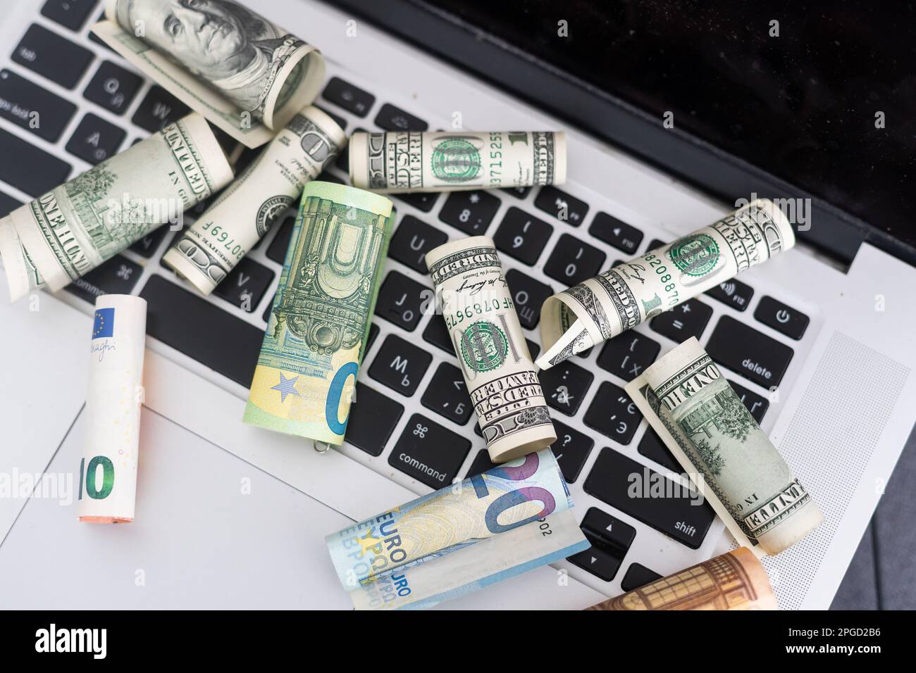 Money on computer keyboard. roll Stock Photo - Alamy
