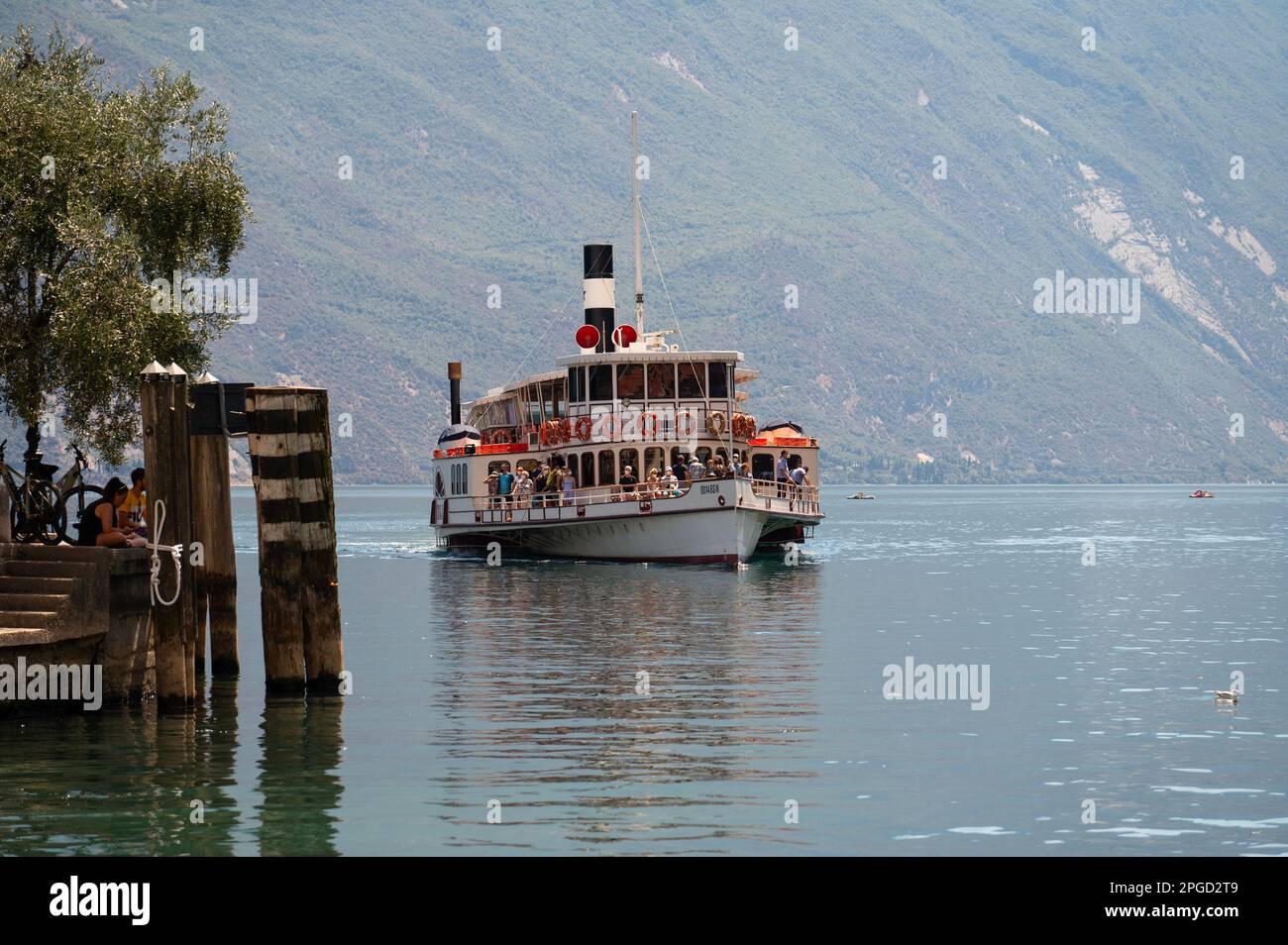 Paddle steamer Italia, vintage passenger boat pulling into Riva on Lake ...