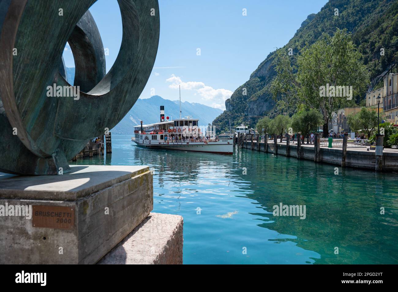 Paddle steamer Italia, vintage passenger boat pulling into Riva on Lake ...