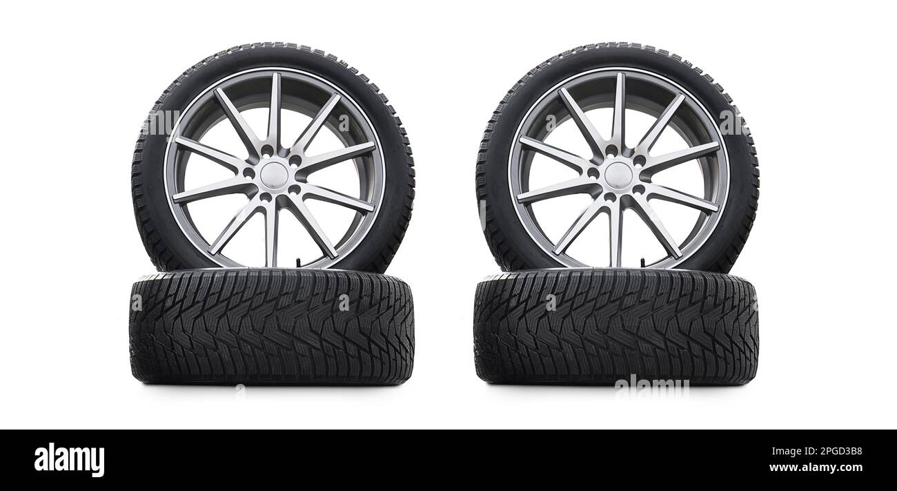Four new good-looking snow tires isolated on the white background. A ...
