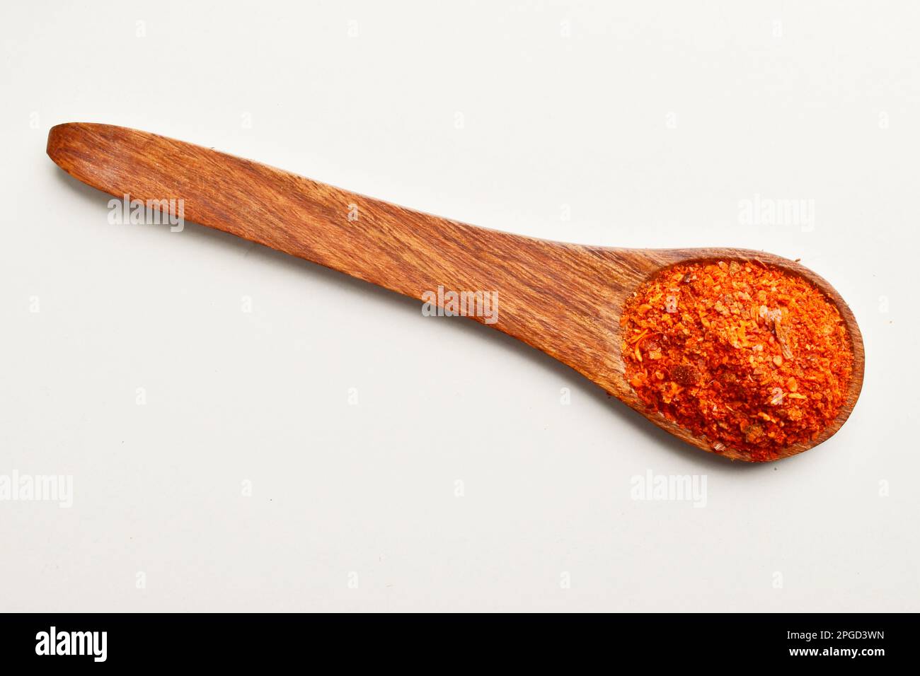 Ground red chilli in wooden spoon isolated on white background Stock ...