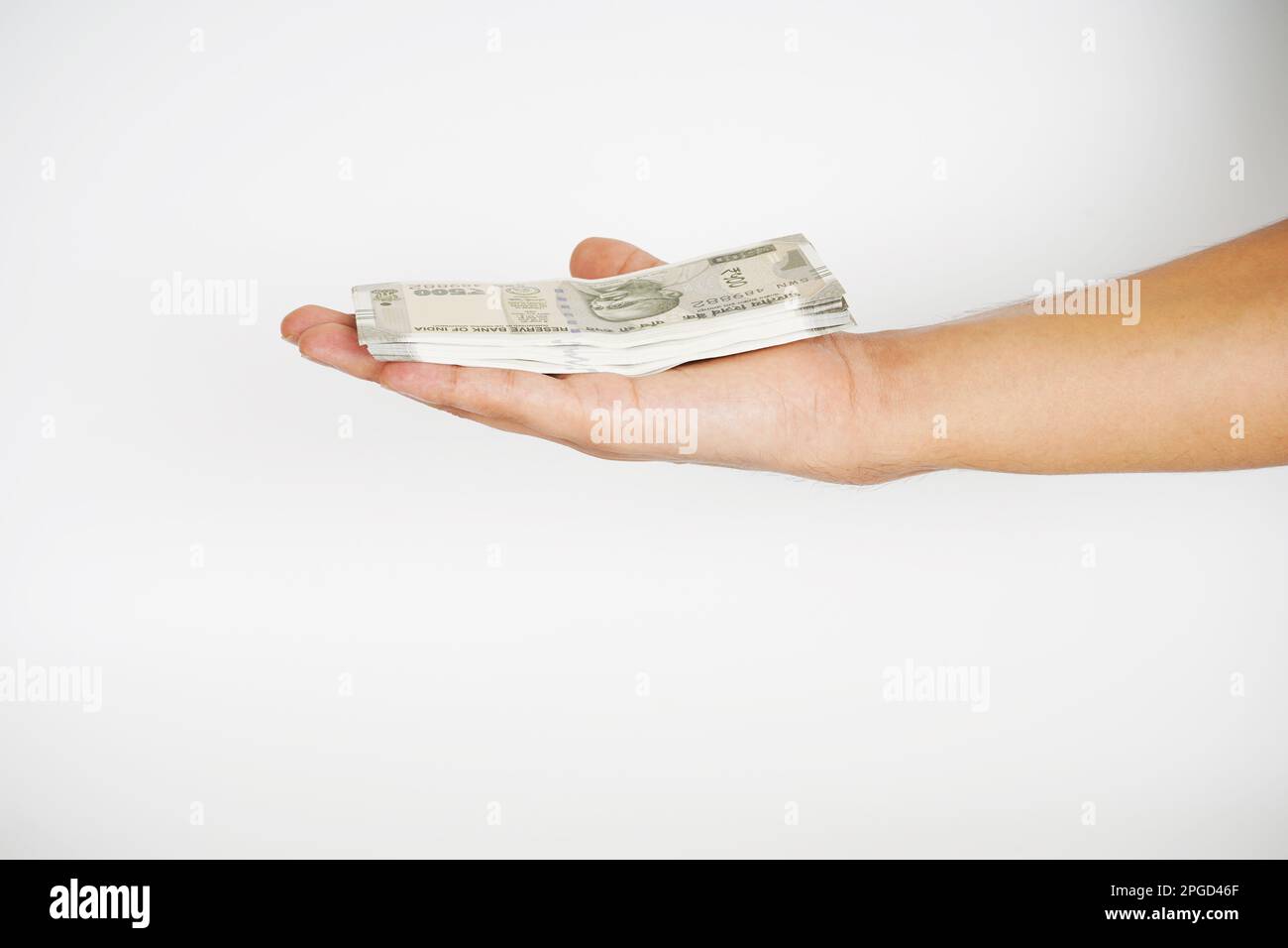 Bundle of indian currency note in hand on white background, money ...