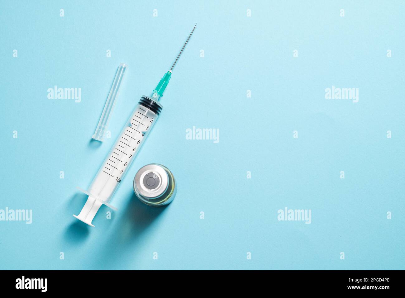 Transparent plastic syringe on blue background with empty copy space ...