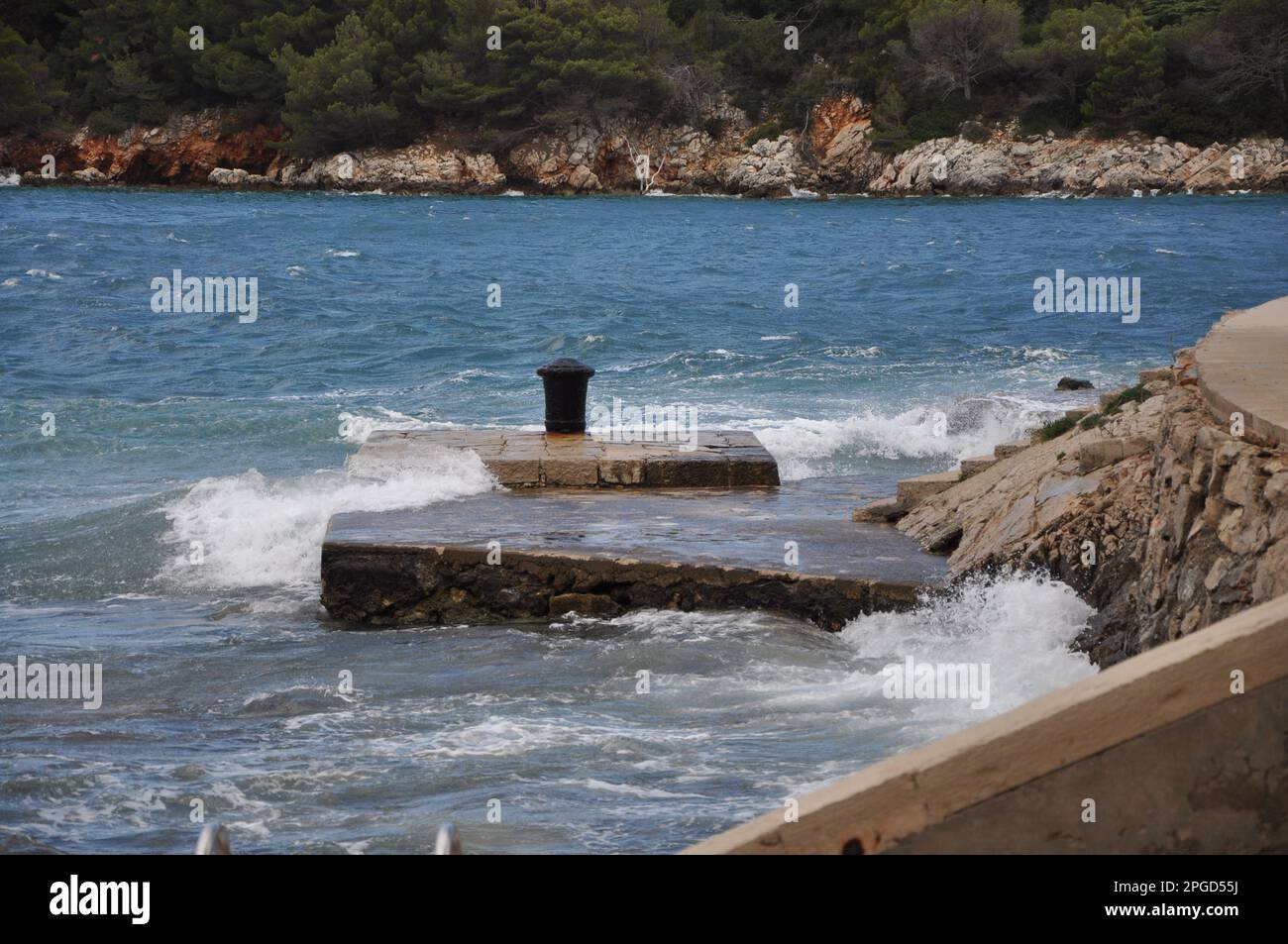 Stone pier with rusty bollard. Completely rusted dilapidated iron ...