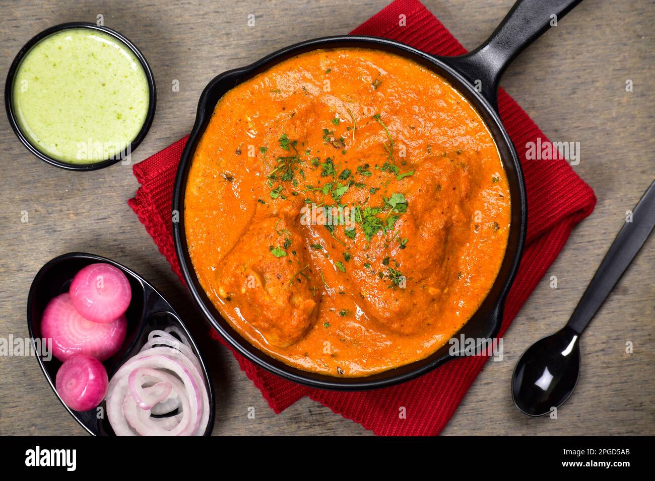 Punjabi food butter chicken with mint chutney and pickled onion Stock ...