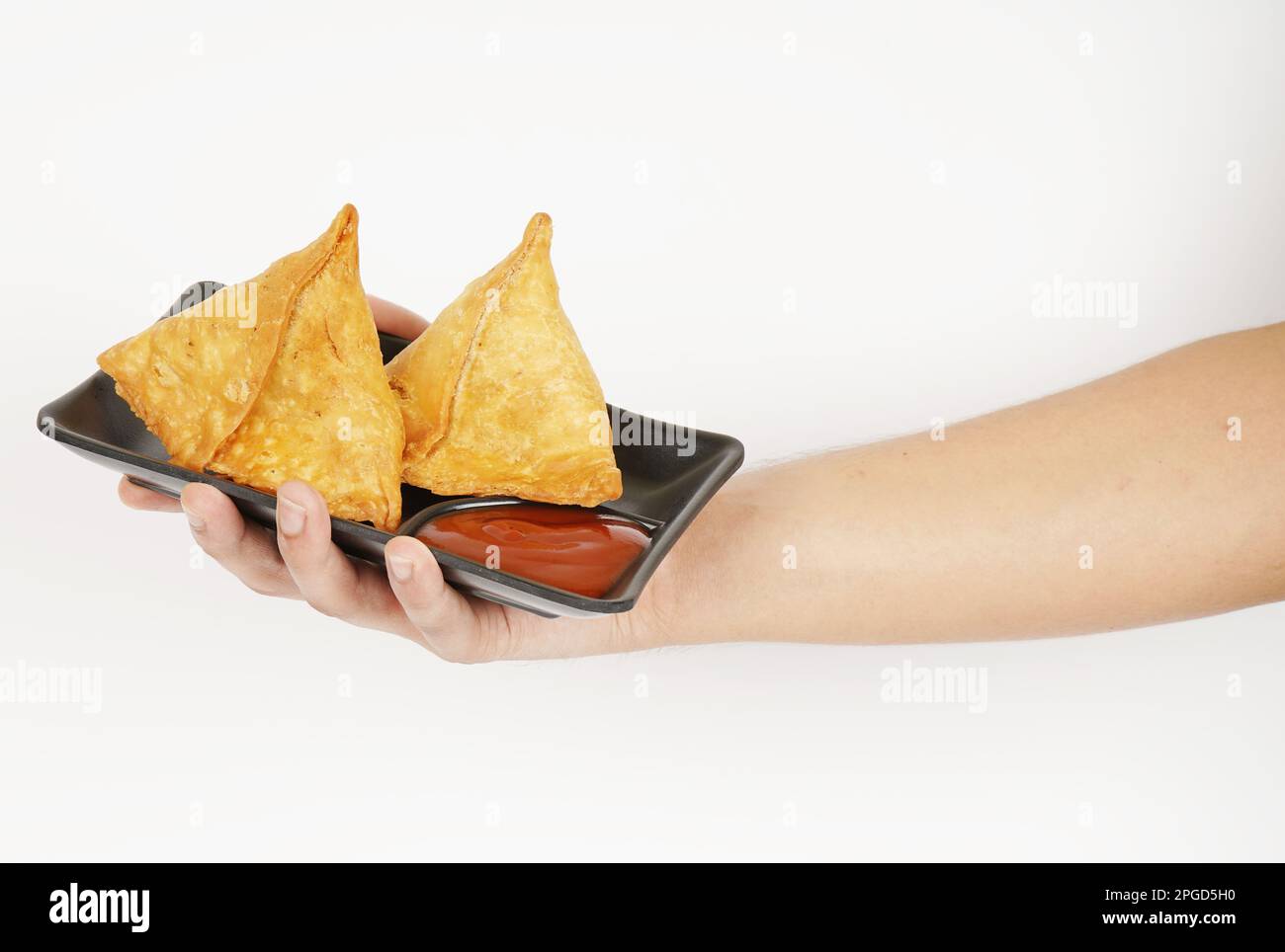Samosa plate in hand isolated on white background, asian snack Stock ...