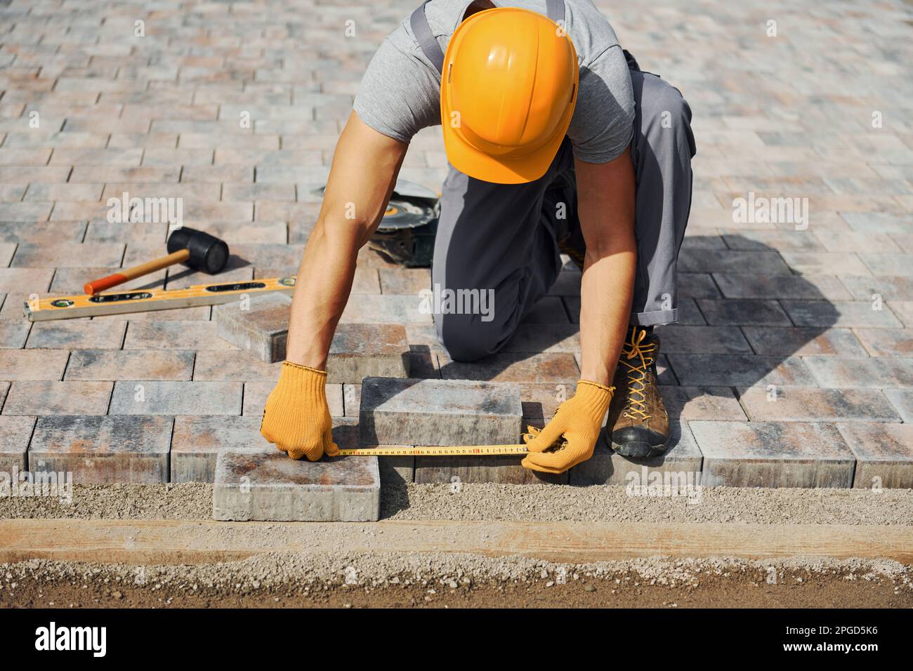 Measuring process. Male worker in yellow colored uniform have job with ...