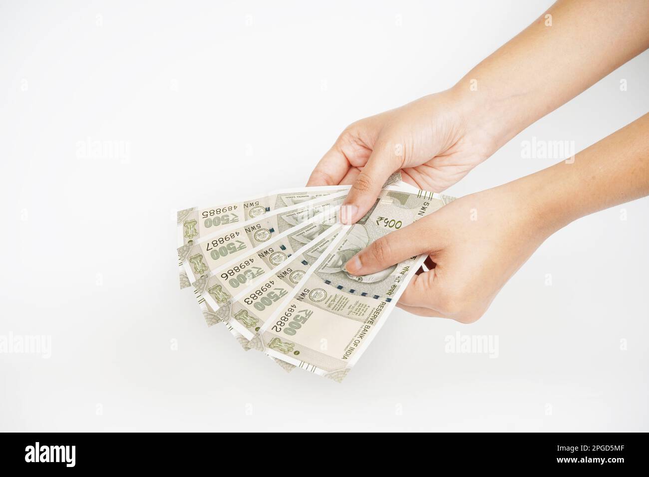 Hand holding indian currency note isolated on white background Stock ...