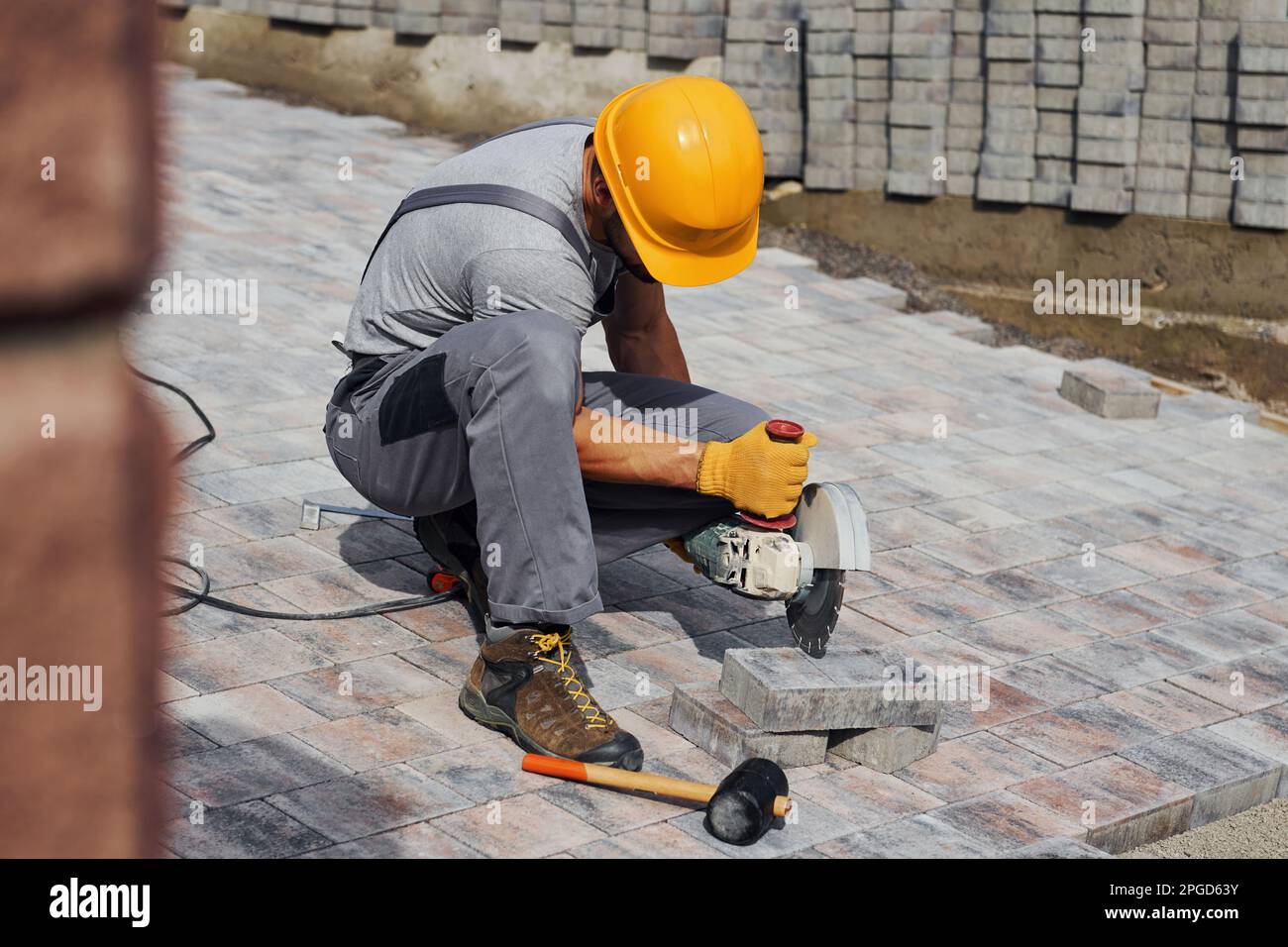 Concentrated at work. Man in yellow colored uniform have job with ...