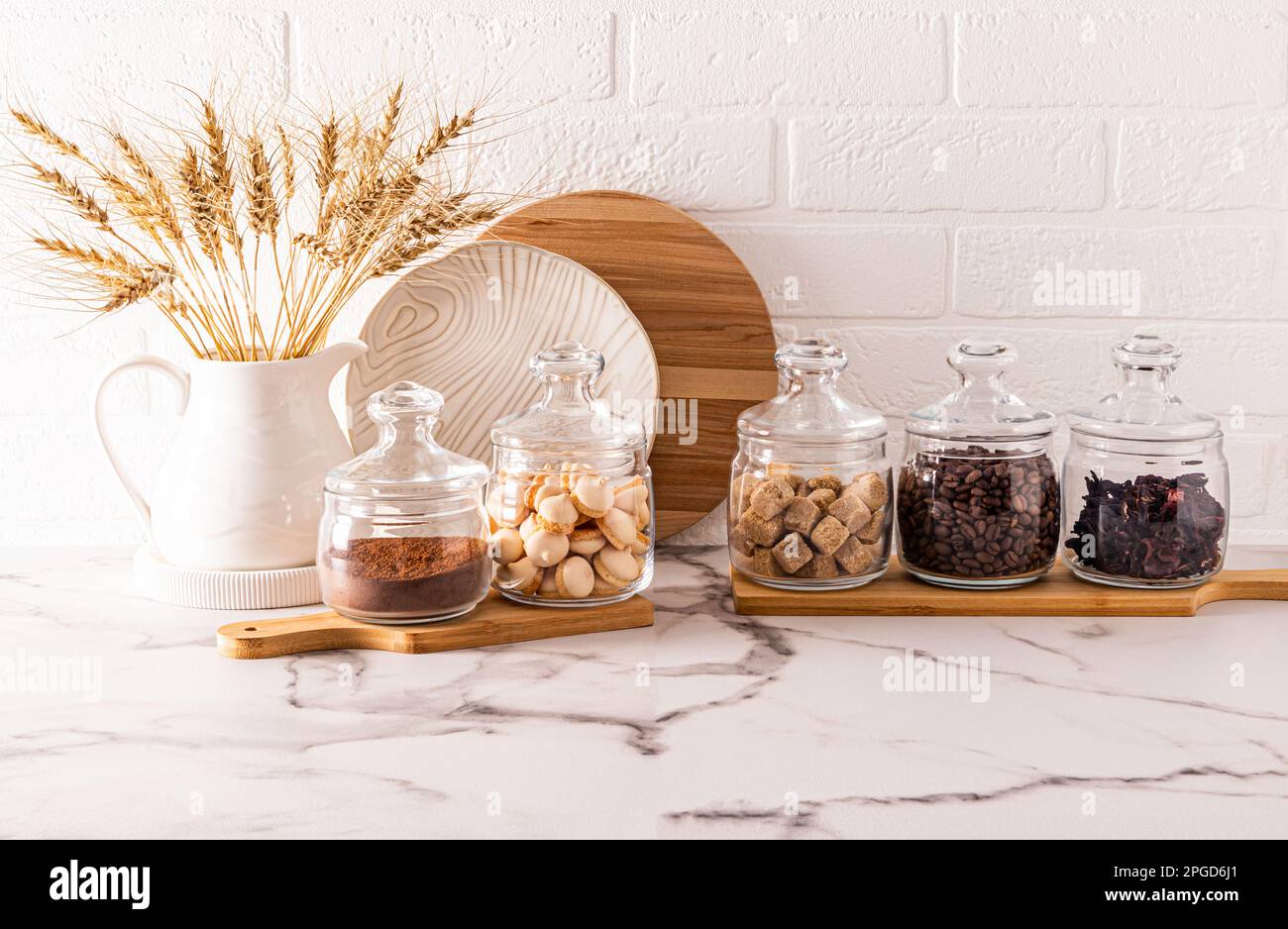 a set of glass jars with various bulk products stand on wooden boards ...