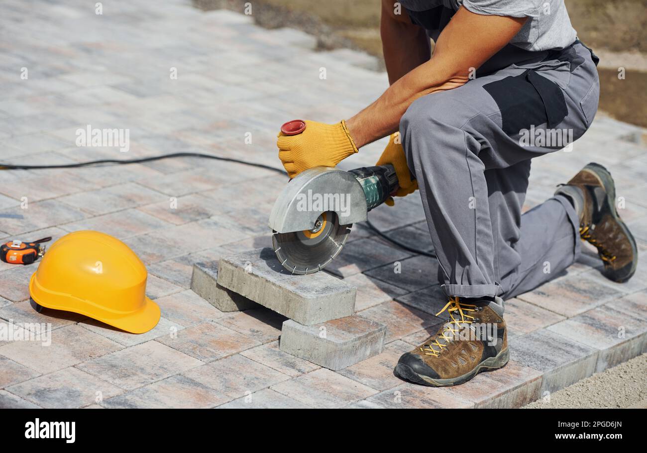 Close up view. Male worker in yellow colored uniform have job with ...