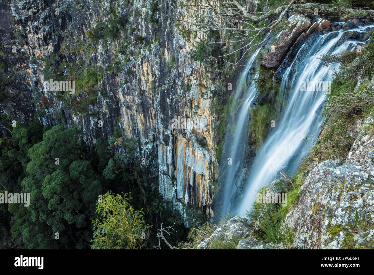 A stunning landscape featuring a powerful waterfall cascading down the ...