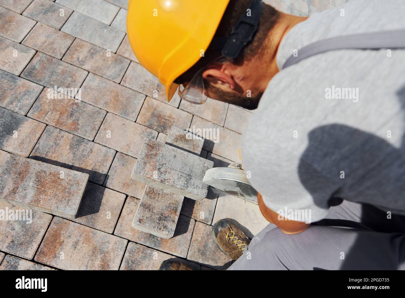 Concentrated at work. Man in yellow colored uniform have job with ...