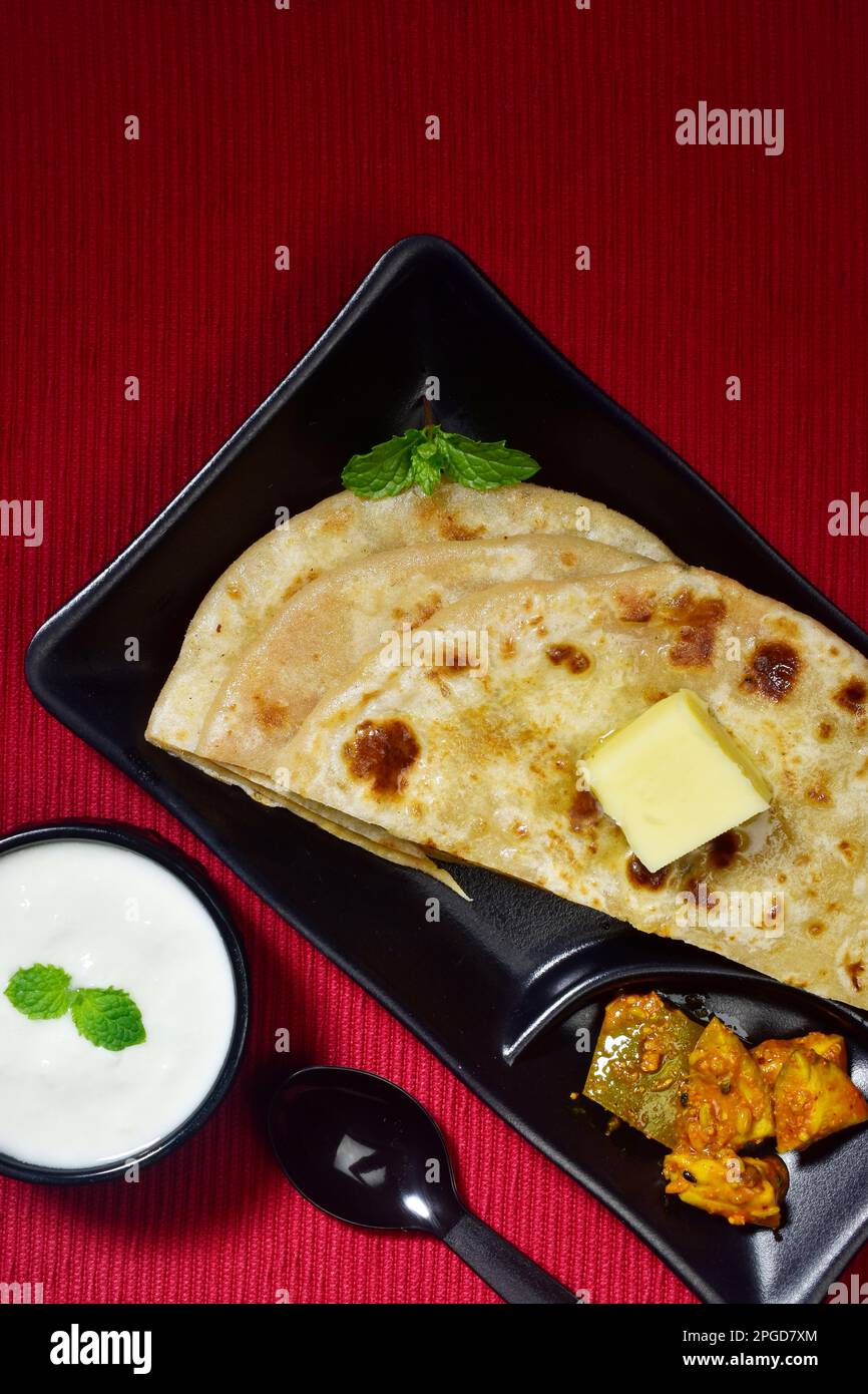 Top view of butter paratha with curd and aachar Stock Photo - Alamy