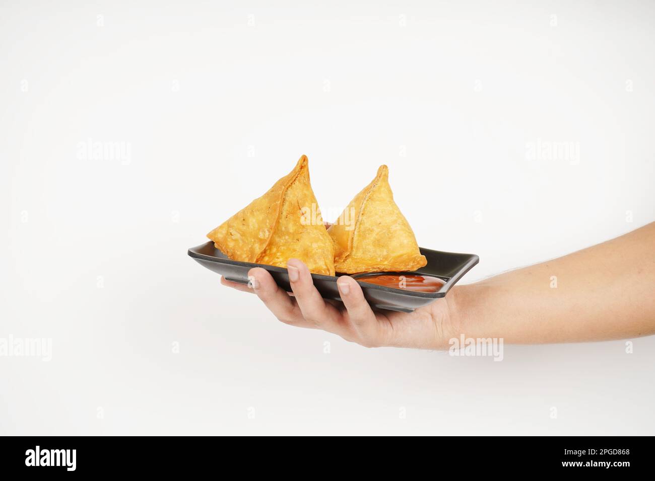 Hand holding samosa plate in hand isolated on white background Stock ...