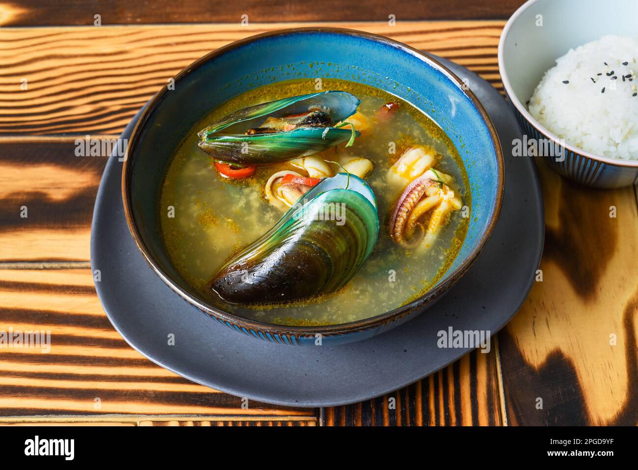 Soup tom yum with mussels side view close up Stock Photo - Alamy