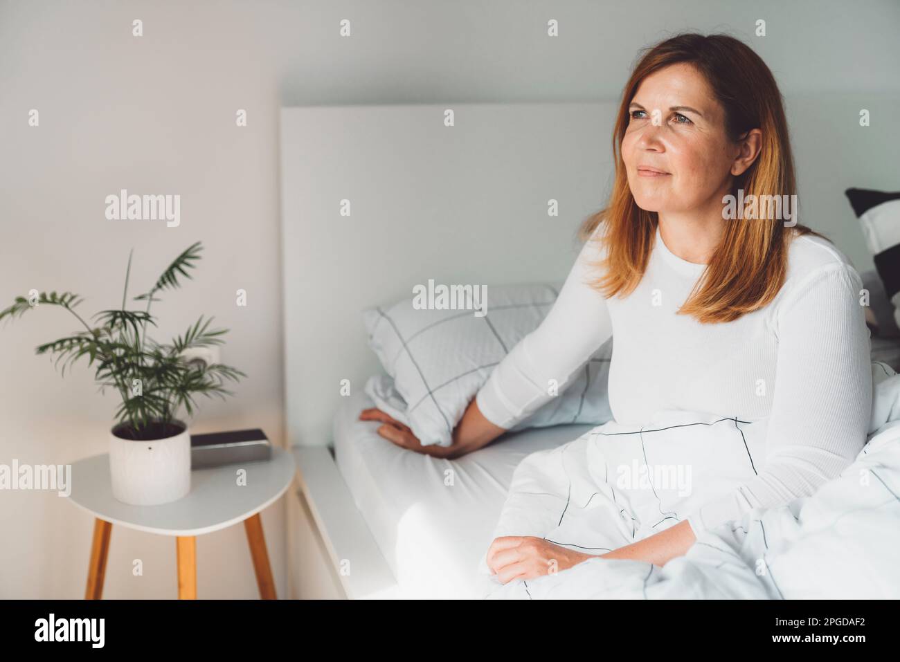 Adult woman getting out of bed in the morning feeling great, looking ...