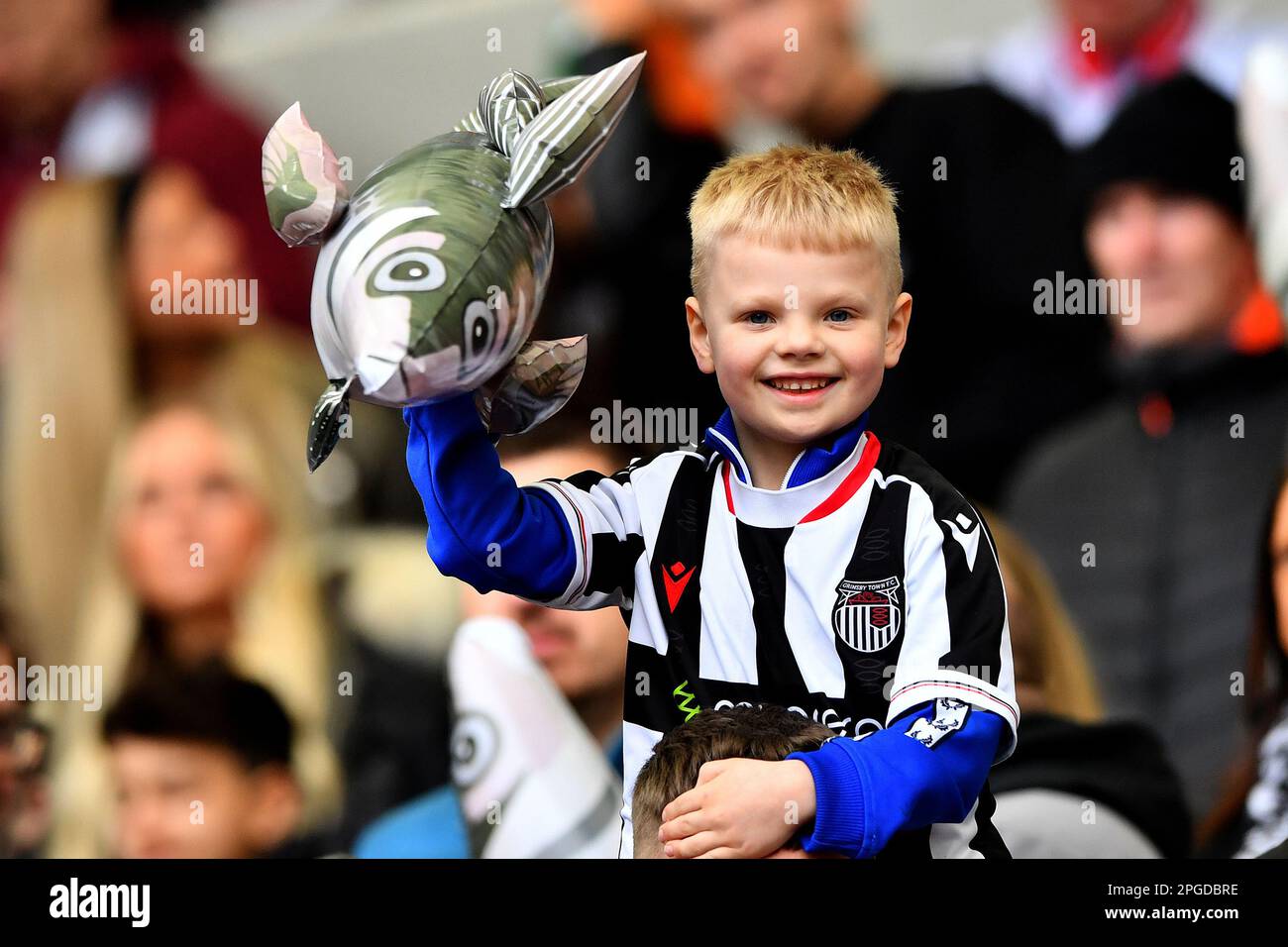 A young Grimsby Town fan is seen with a inflatable Harry the Haddock ...