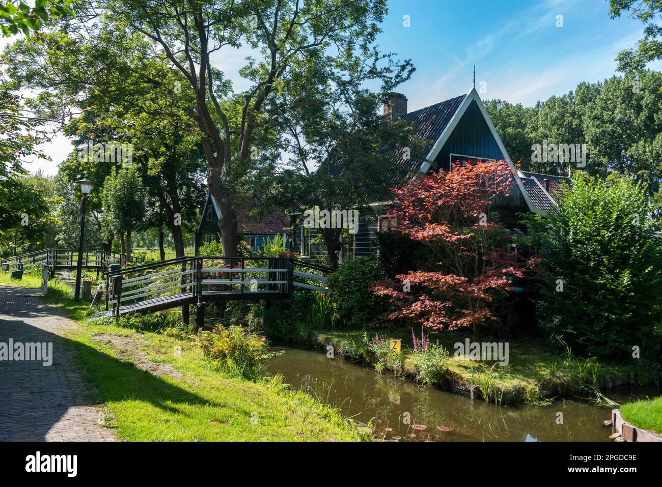 Village scene with front gardens and traditional houses in the street ...