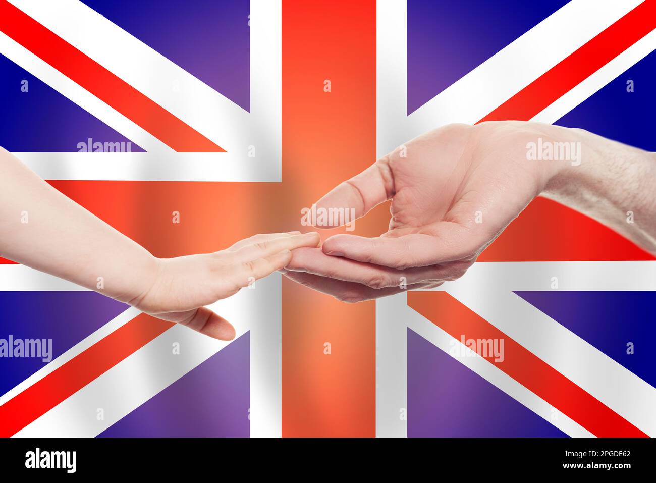 British baby and parent hands on the background of flag of England Help ...