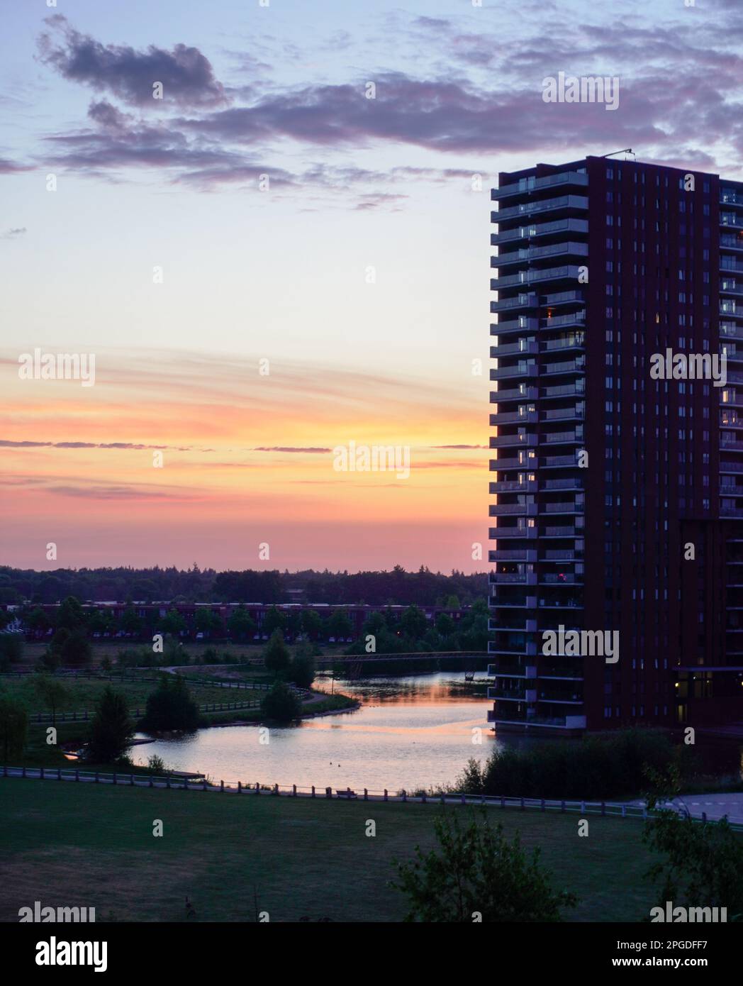 Dutch city buildings during dusk hours with a partially clouded sky ...