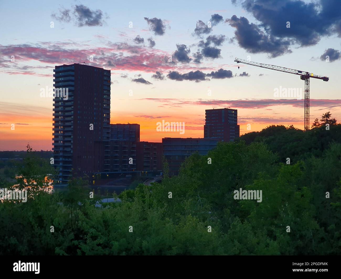 Dutch city buildings during dusk hours with a partially clouded sky ...