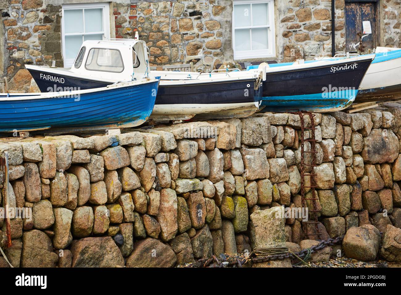 Mousehole, Cornwall, UK - Port wall with fishing boats on top at low ...