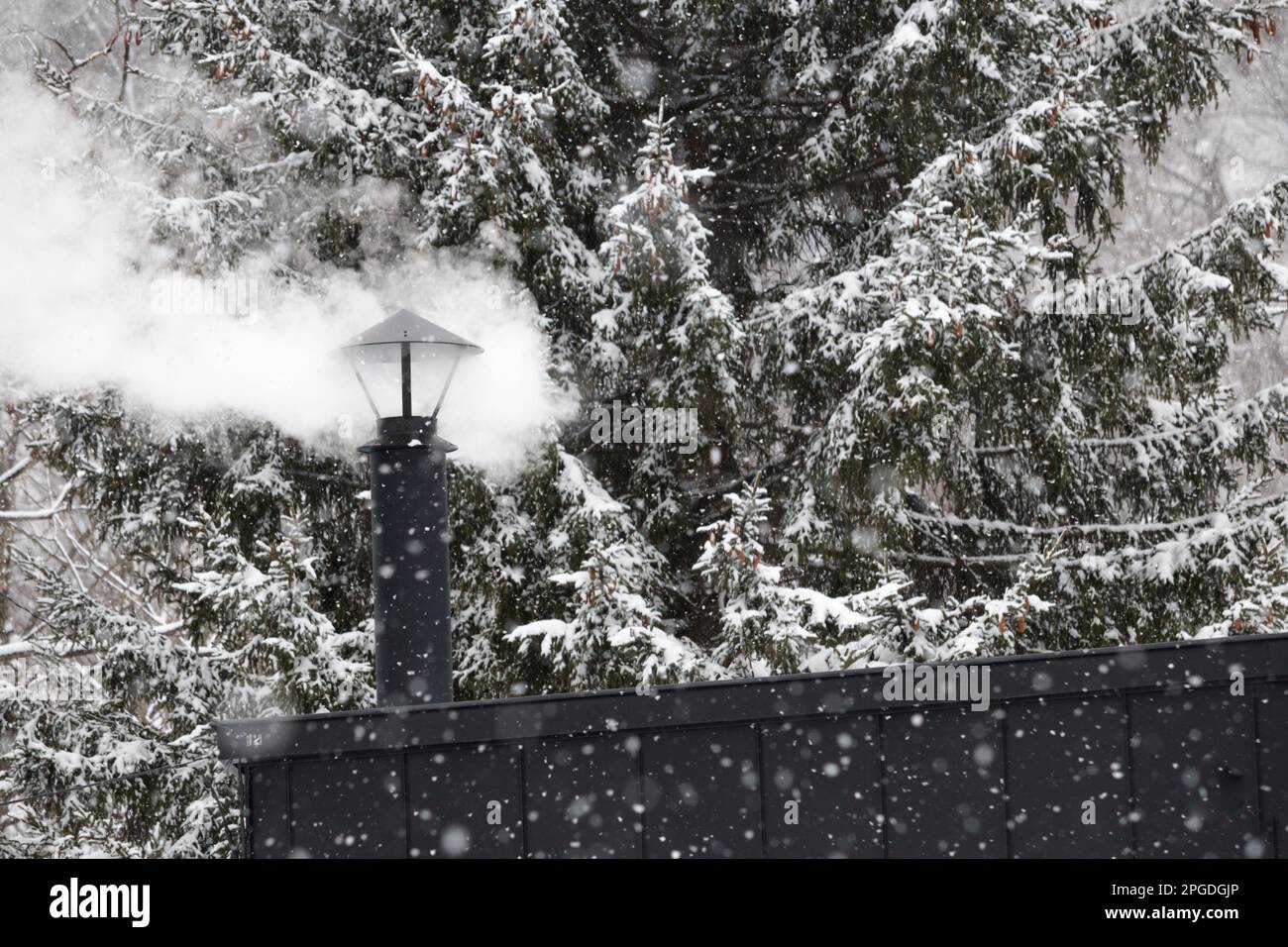 White smoke amd black metal chimney on a snowy day Stock Photo - Alamy