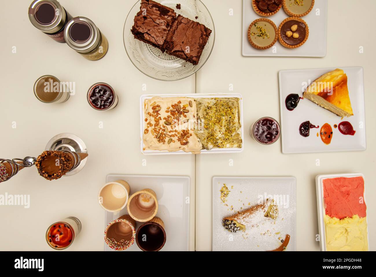 Set of assorted sweets and desserts and ice creams in tubs on a plain ...