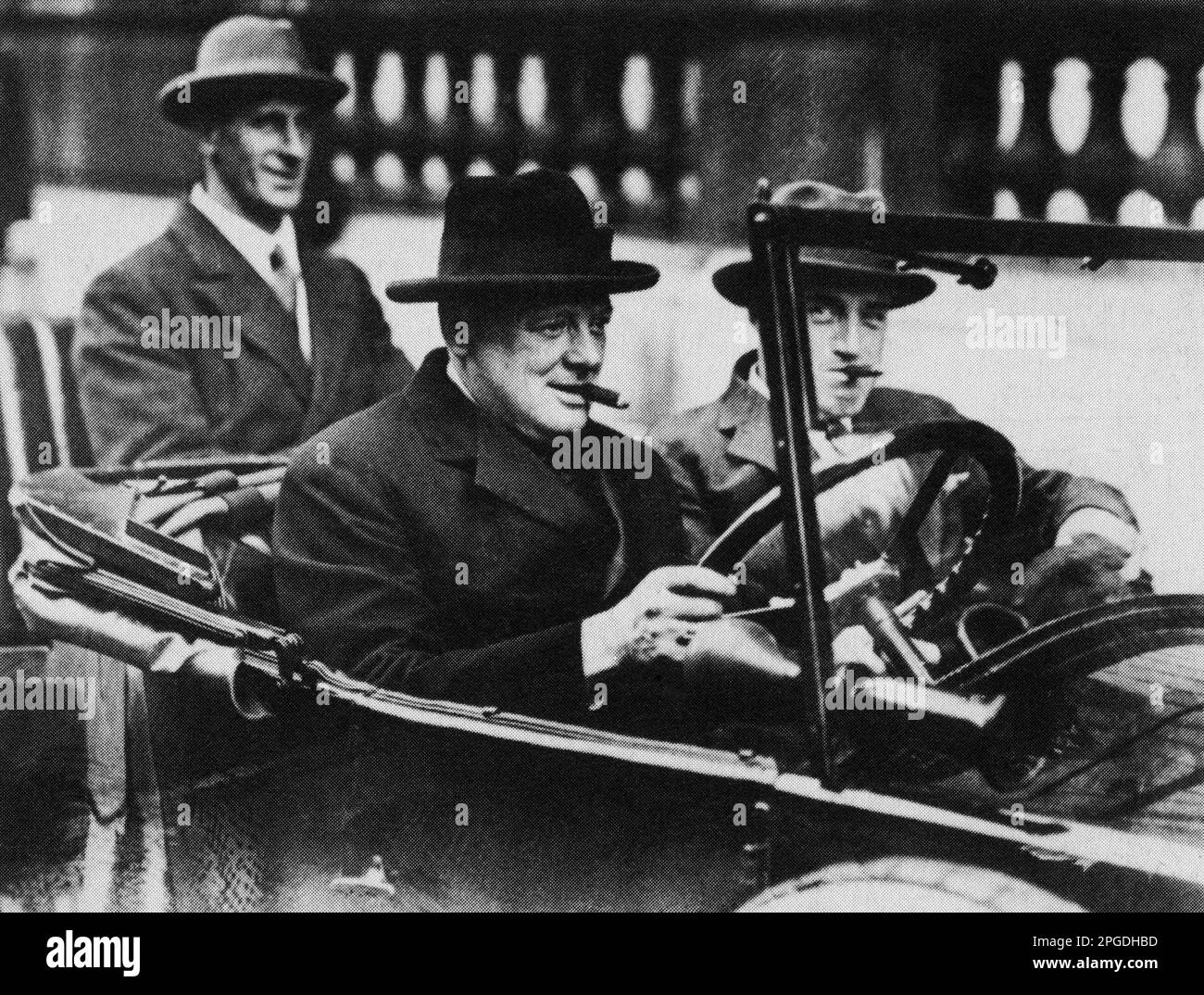 Winston Churchill motoring with his son Randolph. Behind them is ...