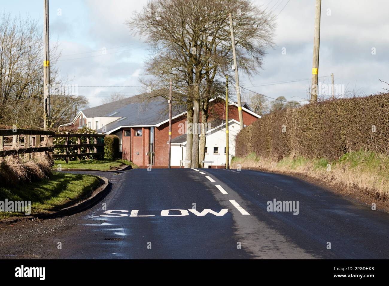 slow written on the approach to a small crest in the road before ...
