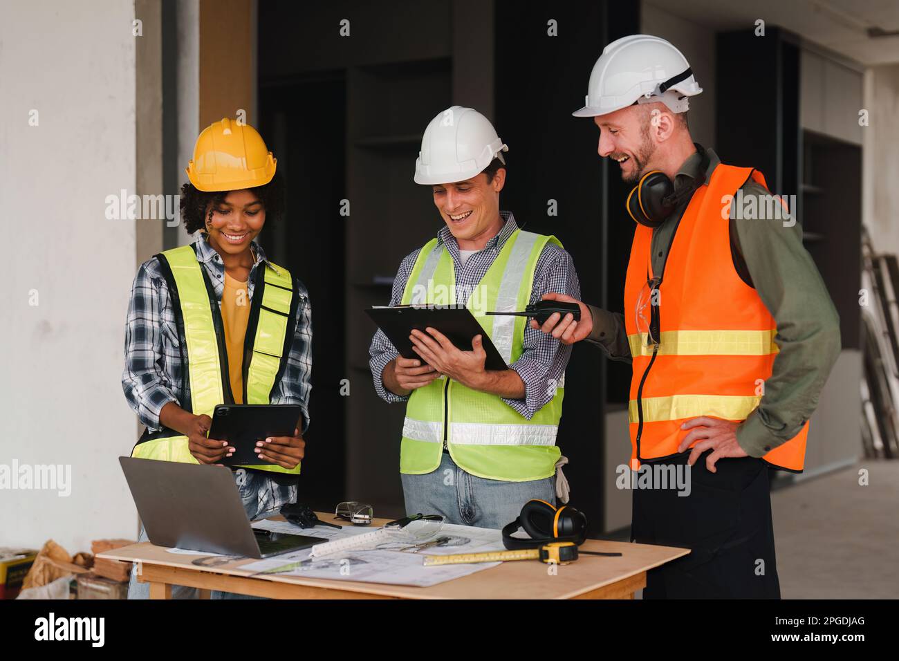 Engineer and Foreman builder team at construction site. American ...