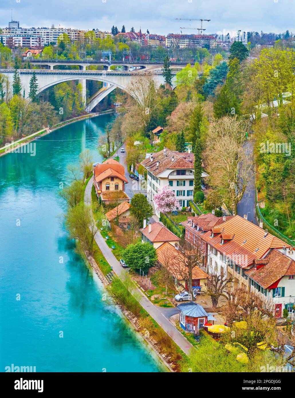The riverside of Aare river with its bridges, buildings and walking ...