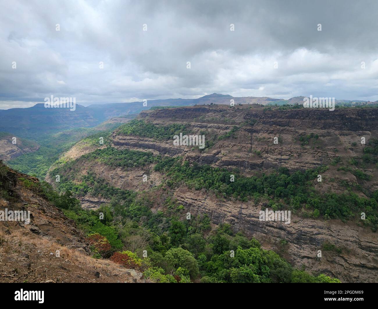A scenic landscape featuring a picturesque valley with hills on either ...